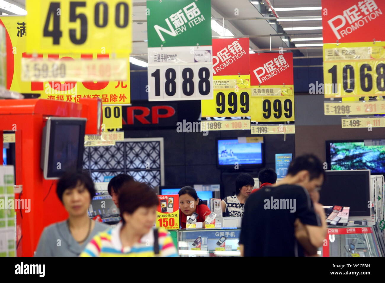 --FILE--Chinese shoppers look at products on sale during a promotion at ...