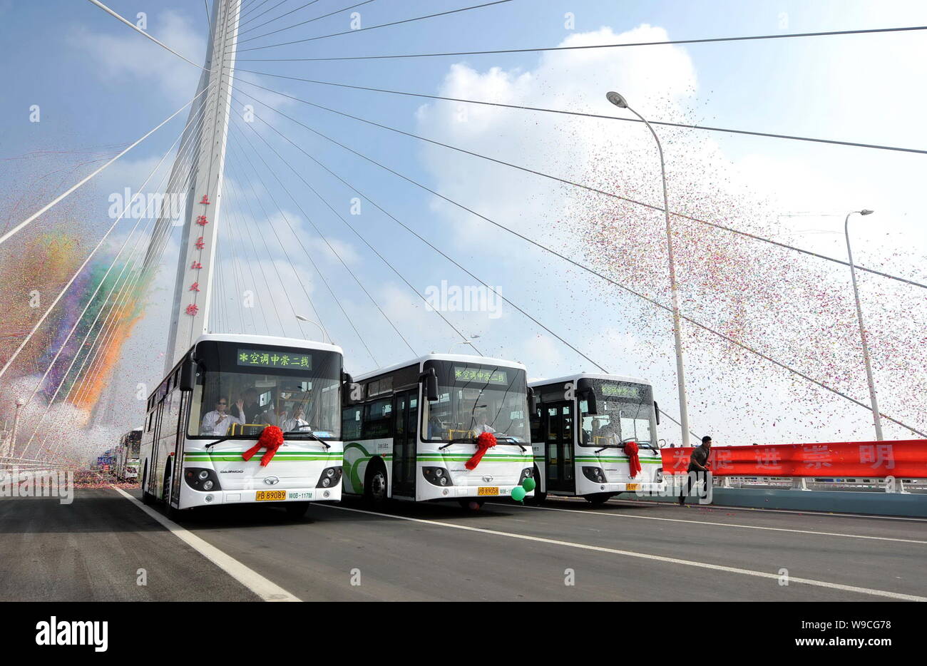 Buses drive across the Shanghai Yangtze River Bridge which links ...