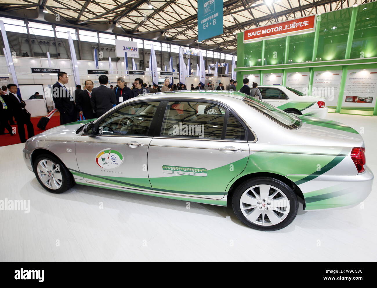 A hybrid car, front, and a fuel cell car are seen on display at the ...