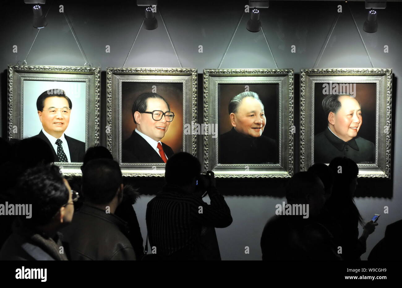 Chinese visitors look at porcelain boards with the portraits of (from ...