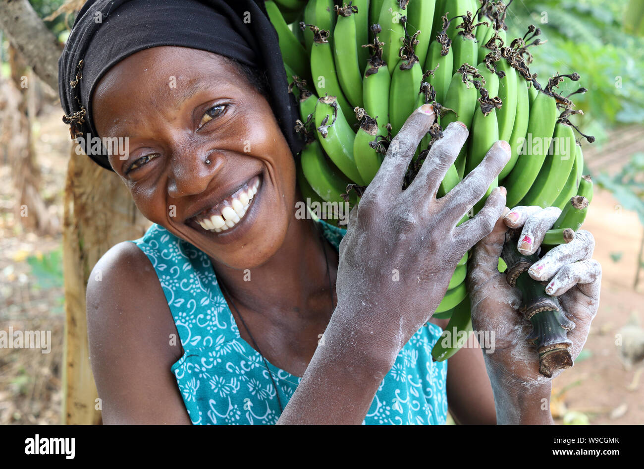 Beautiful woman carries bananas in a rural village on Ukerewe Island ...