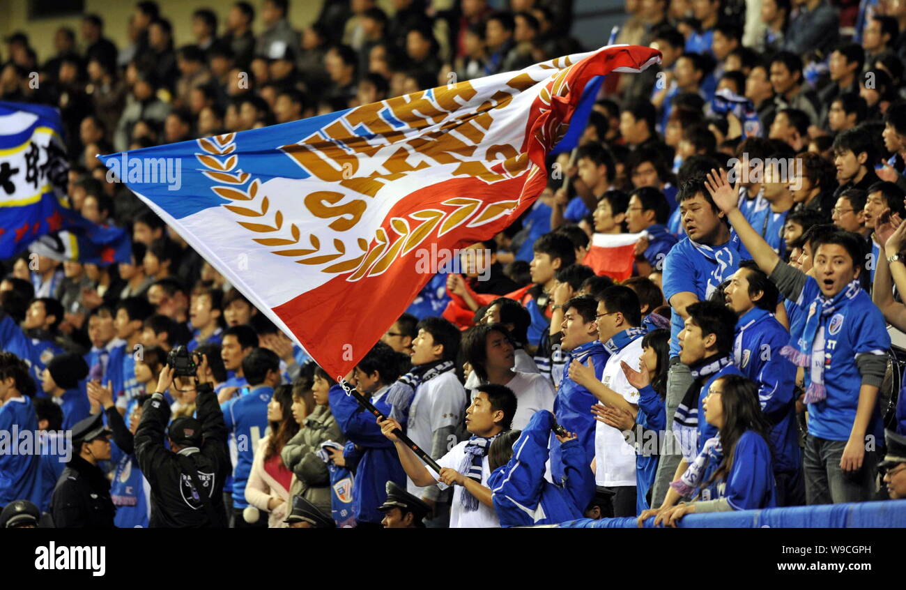 Chinese soccer fans chant slogans to show support for Shanghai Shenhua ...