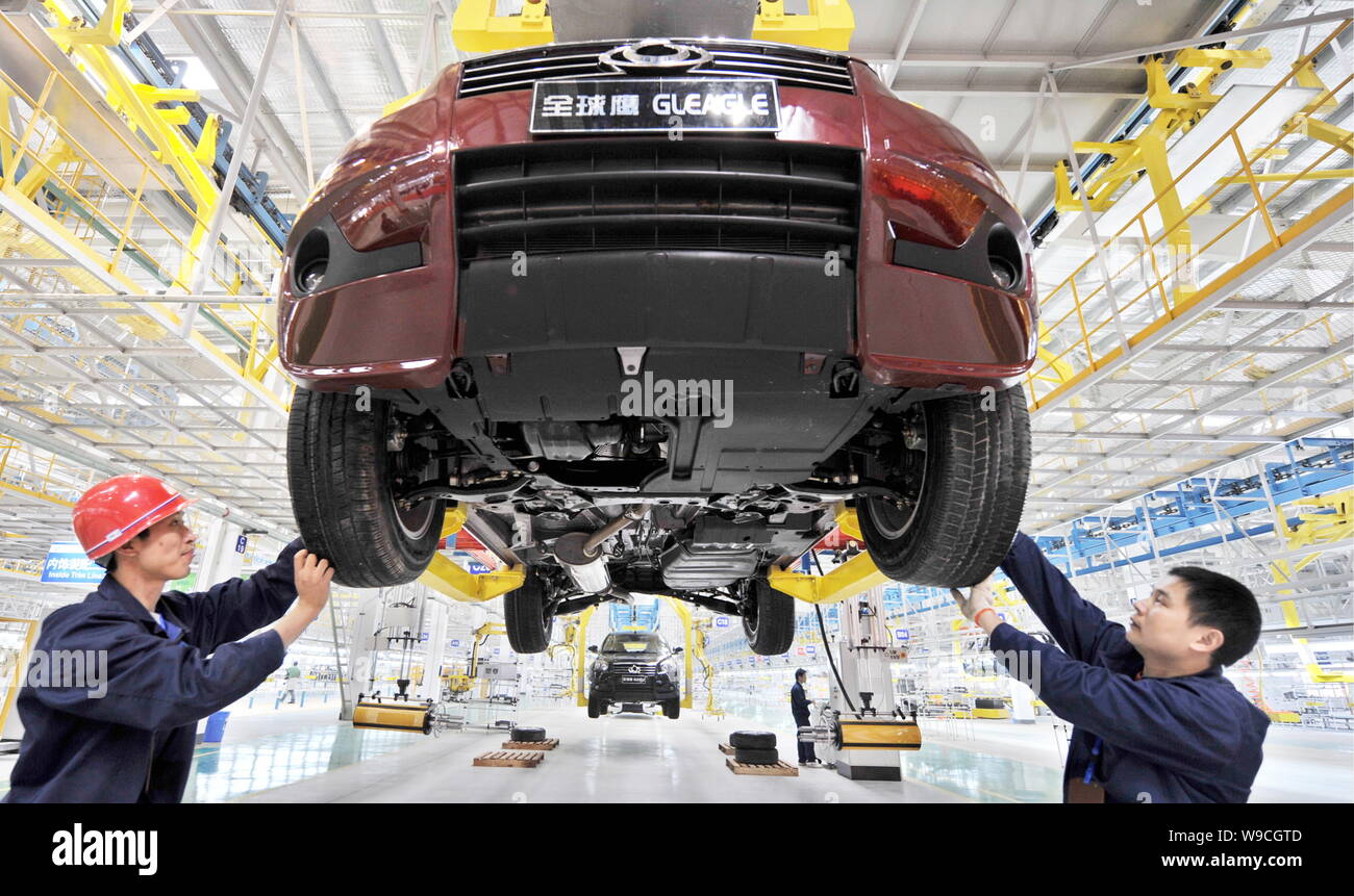 Chinese factory workers assemble a Geely Gleagle SUV at the Geely auto ...