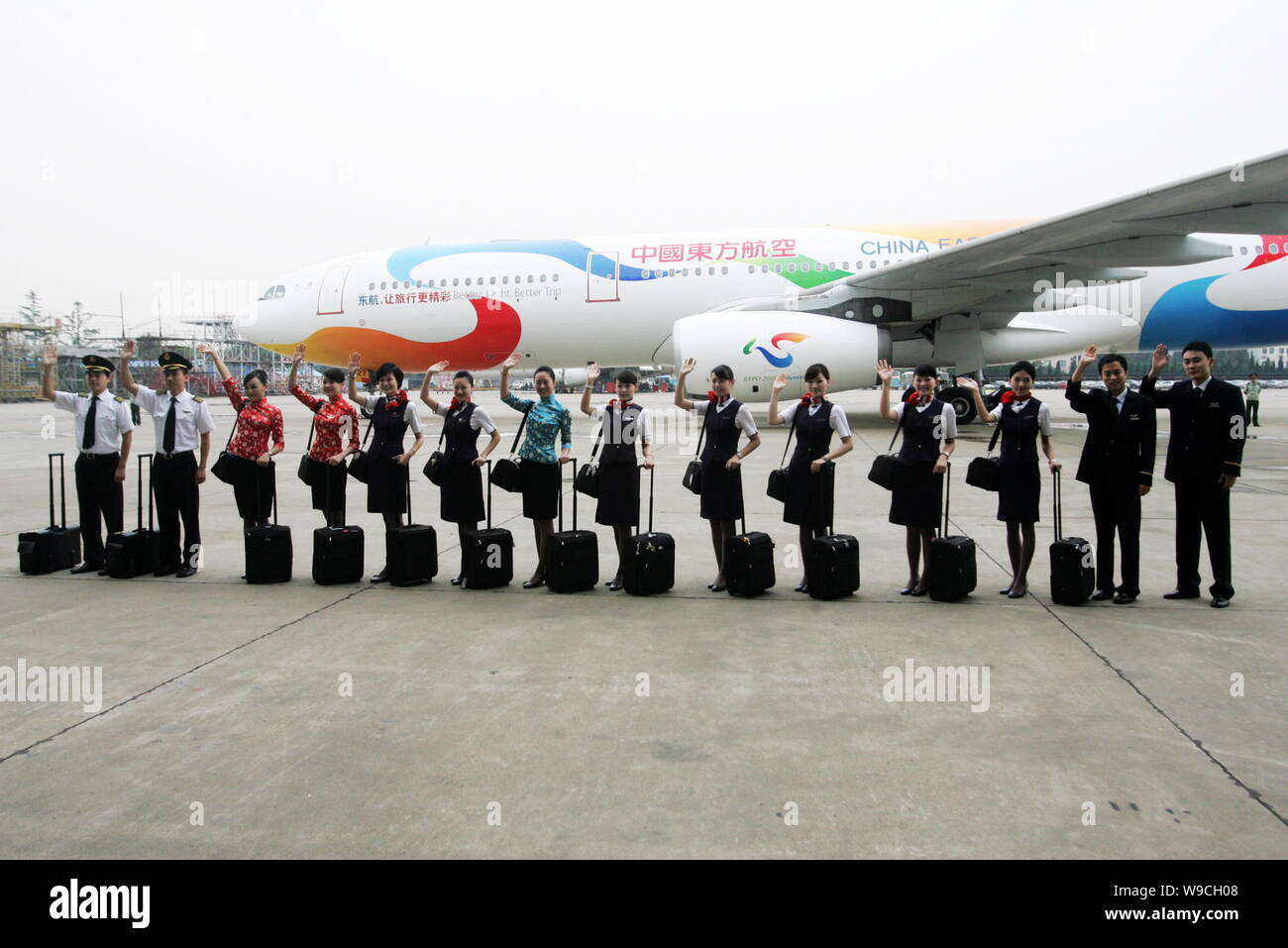 Chinese crew members of China Eastern Airlines wave in front of an ...