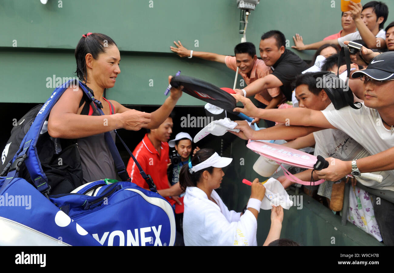 Kimiko Date Krumm of Japan, left, signs for fans after she and Chinas ...