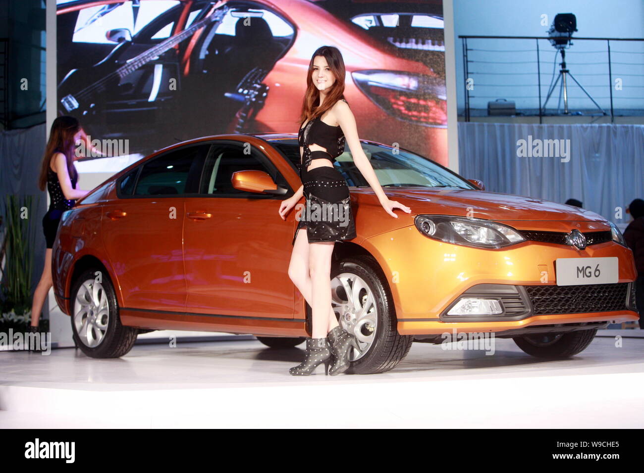 Models pose with an MG6, manufactured by SAIC Motor, during a launch ...