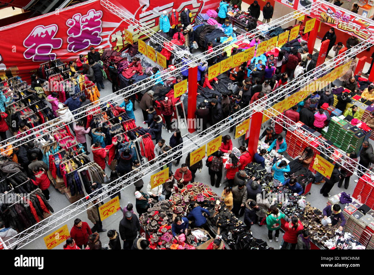 --FILE--Chinese customers shop for apparel on sale during a promotion ...