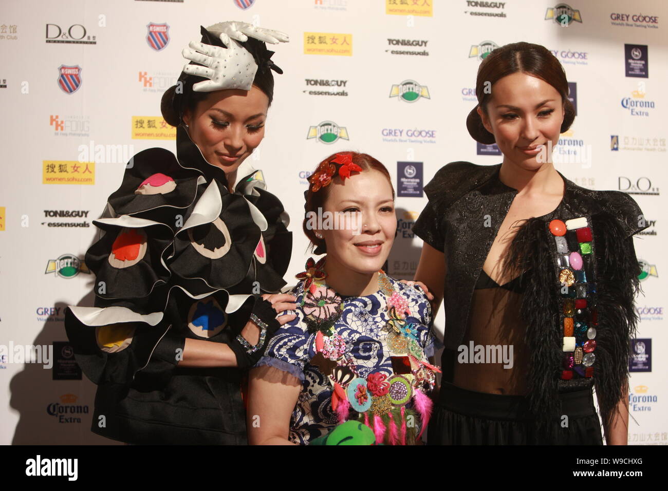Taiwanese designer Chris Chang (C) poses with two models after her ...