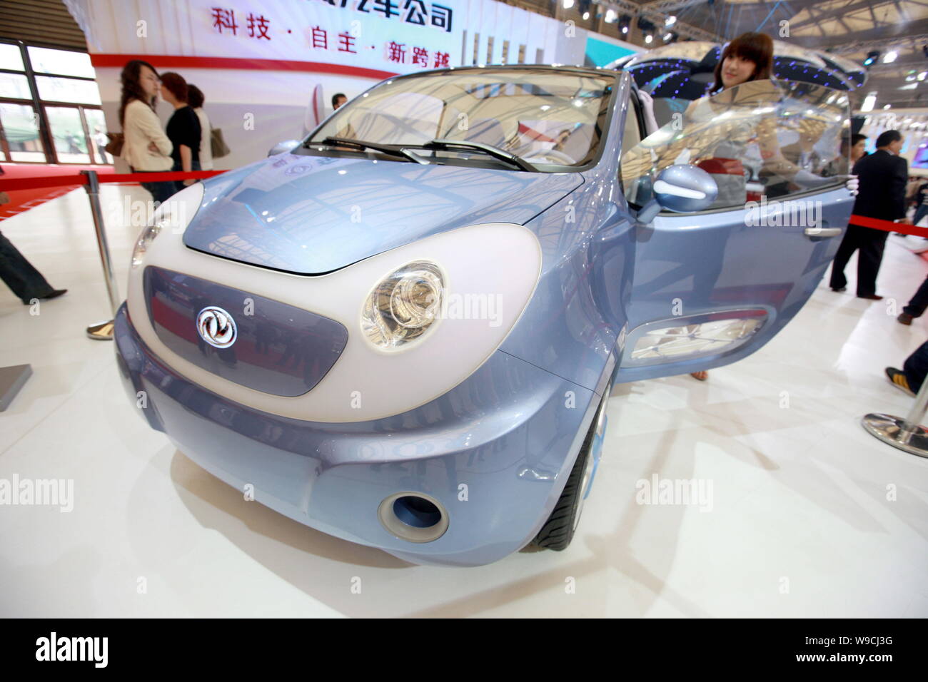 A model poses with a Dongfeng I-Car at the 13th Shanghai International ...