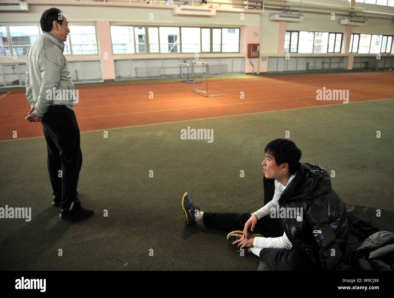 Sun Haiping, left, the coach of Chinese star hurdler Liu Xiang, stands ...