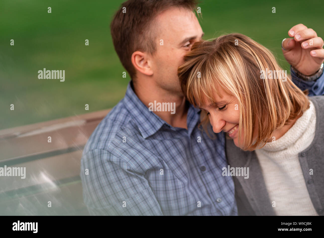 Happy young couple hugging and laughing together in the park outdoor ...
