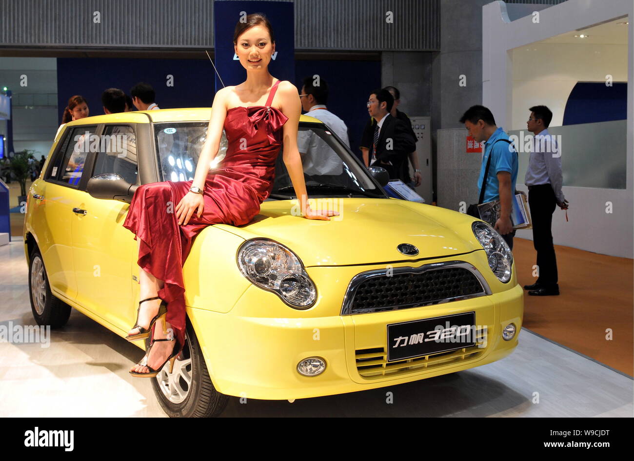--FILE--A Chinese model poses with a Lifan 320 during a fair in ...