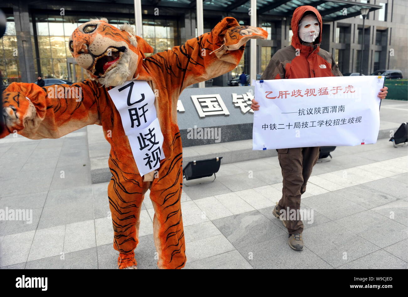 A Chinese human rights activist shows signs of complaints next to a ...