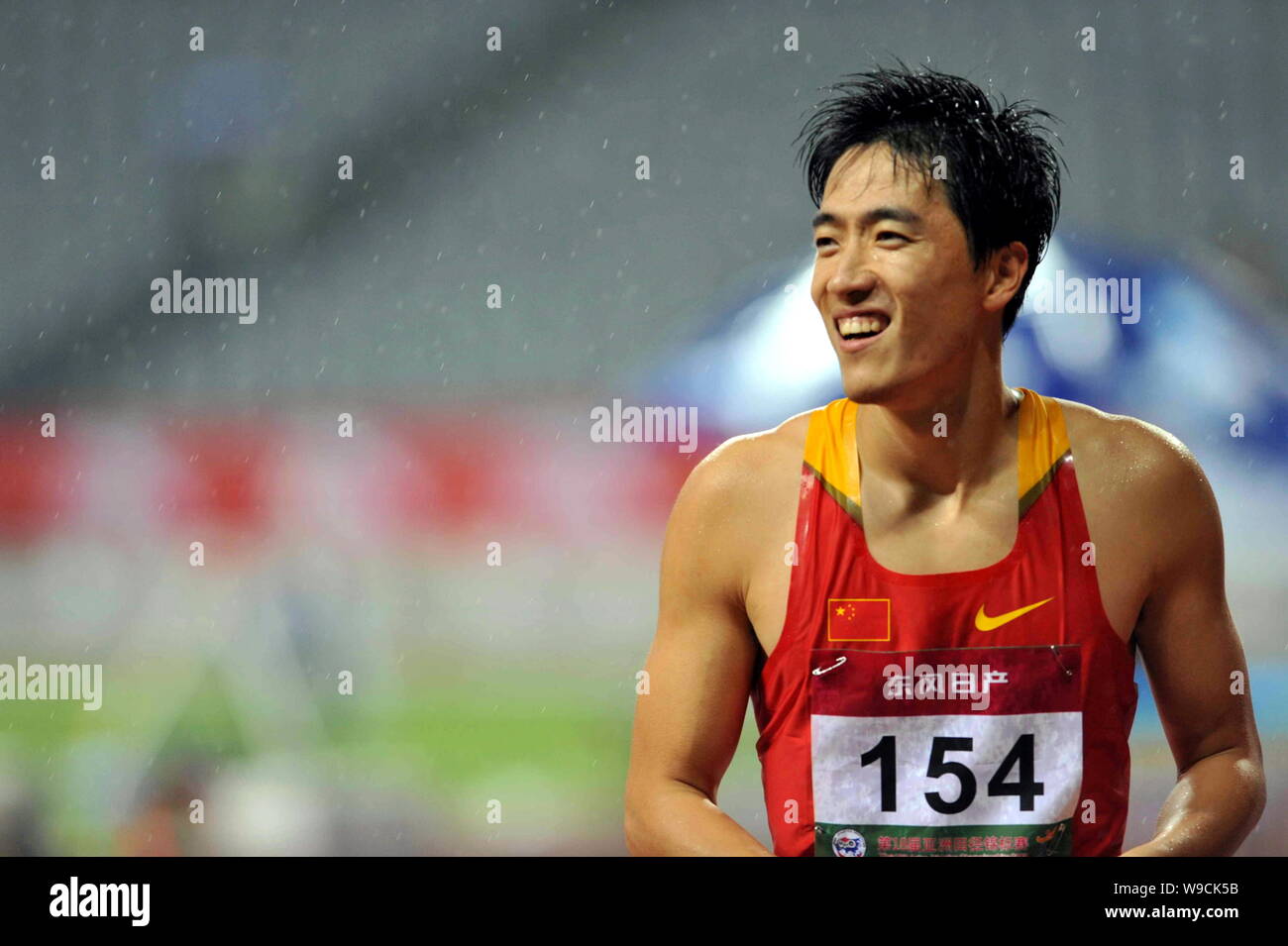 Chinese hurdler Liu Xiang reacts after winning the mens 110m hurdles ...