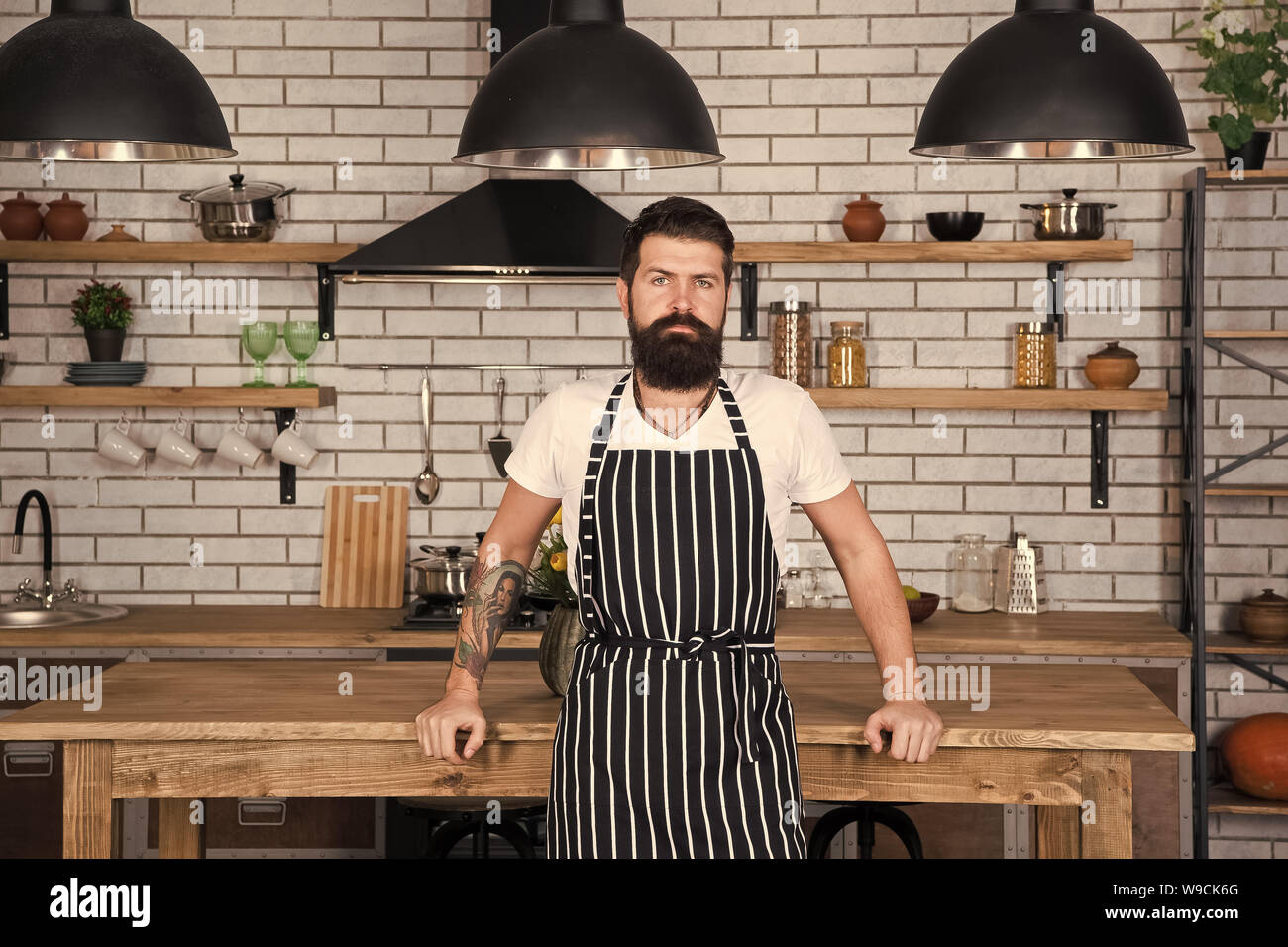 He is a champion in the kitchen. Hipster in kitchen. Mature male ...