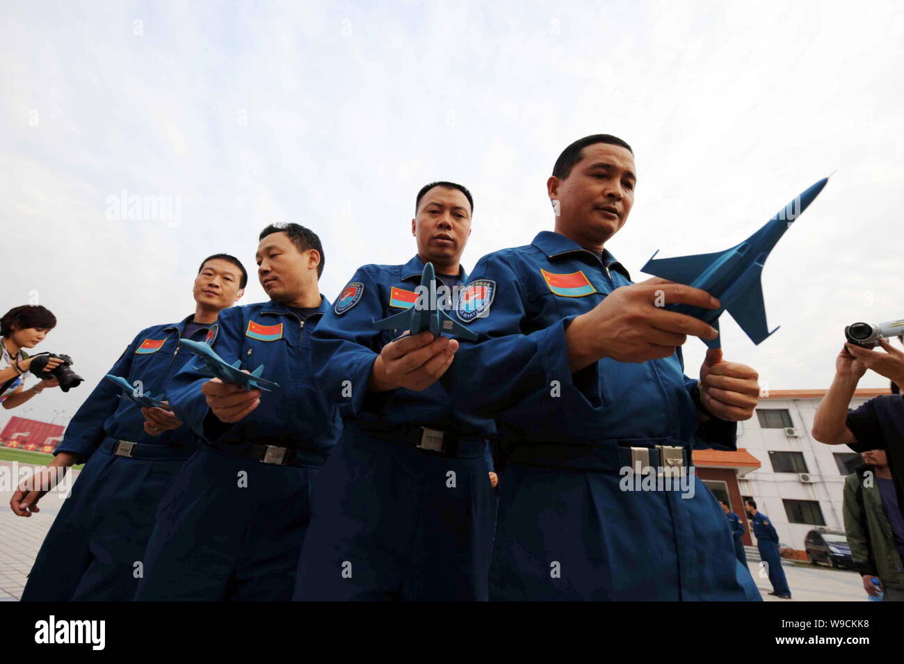 Chinese PLA Air Force pilots holding model fighter planes practise ...