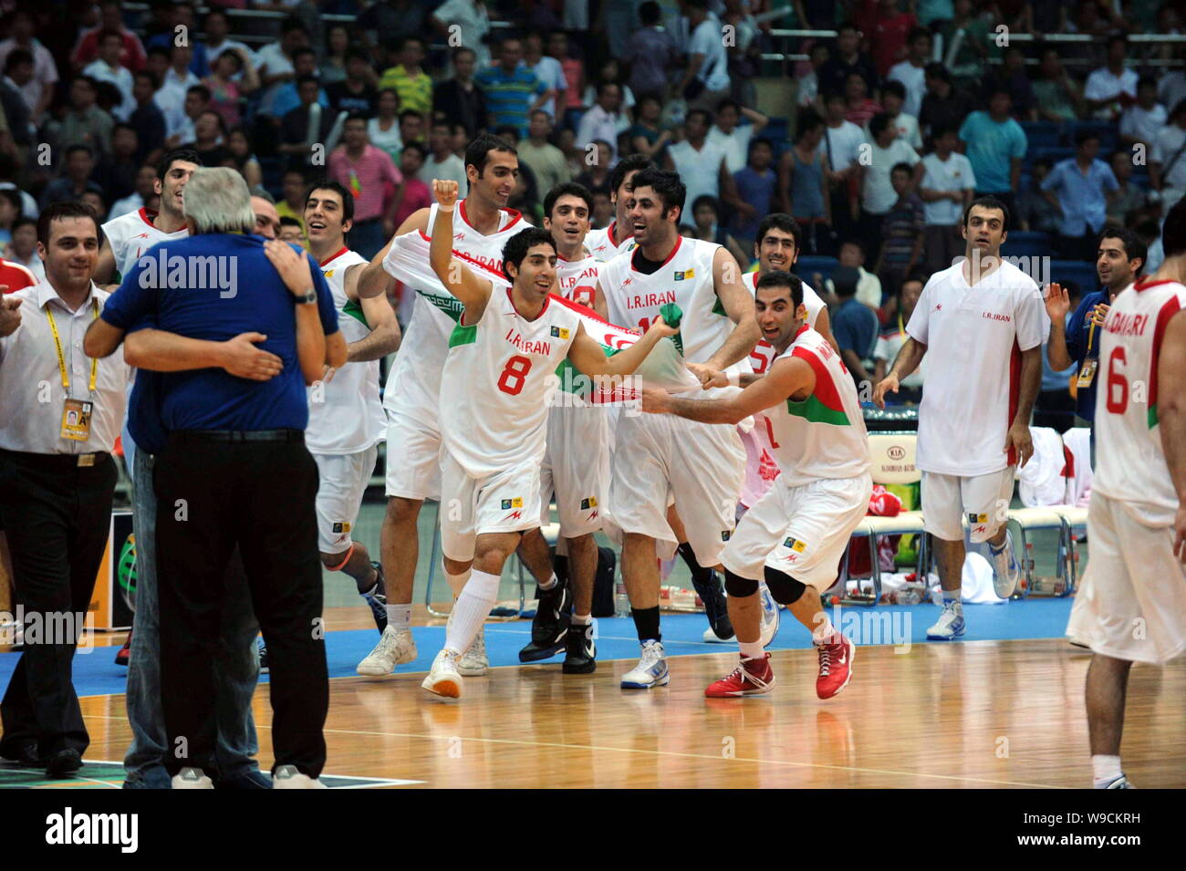 Iranian team members celebrate after defeating China during the 25th ...