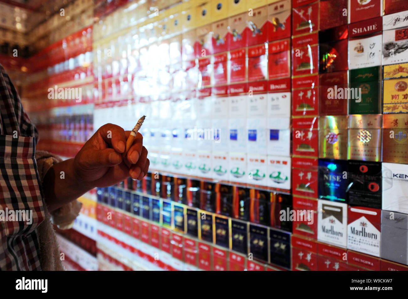 Chinese collector Wang Guohua looks at his collections of cigarette ...