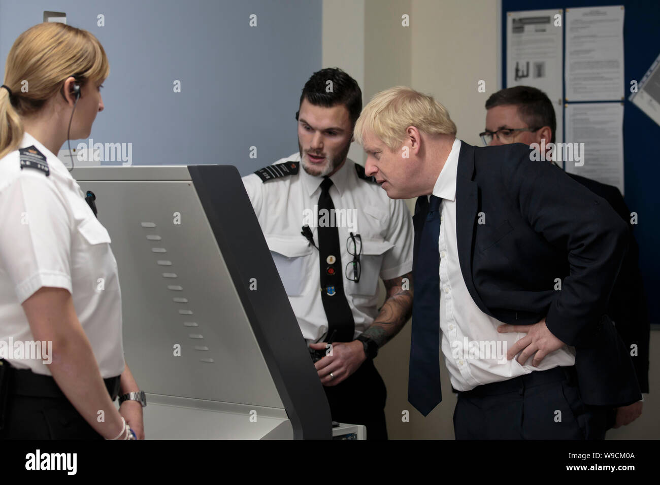 Prime Minister Boris Johnson talks with prison staff by a scanning ...