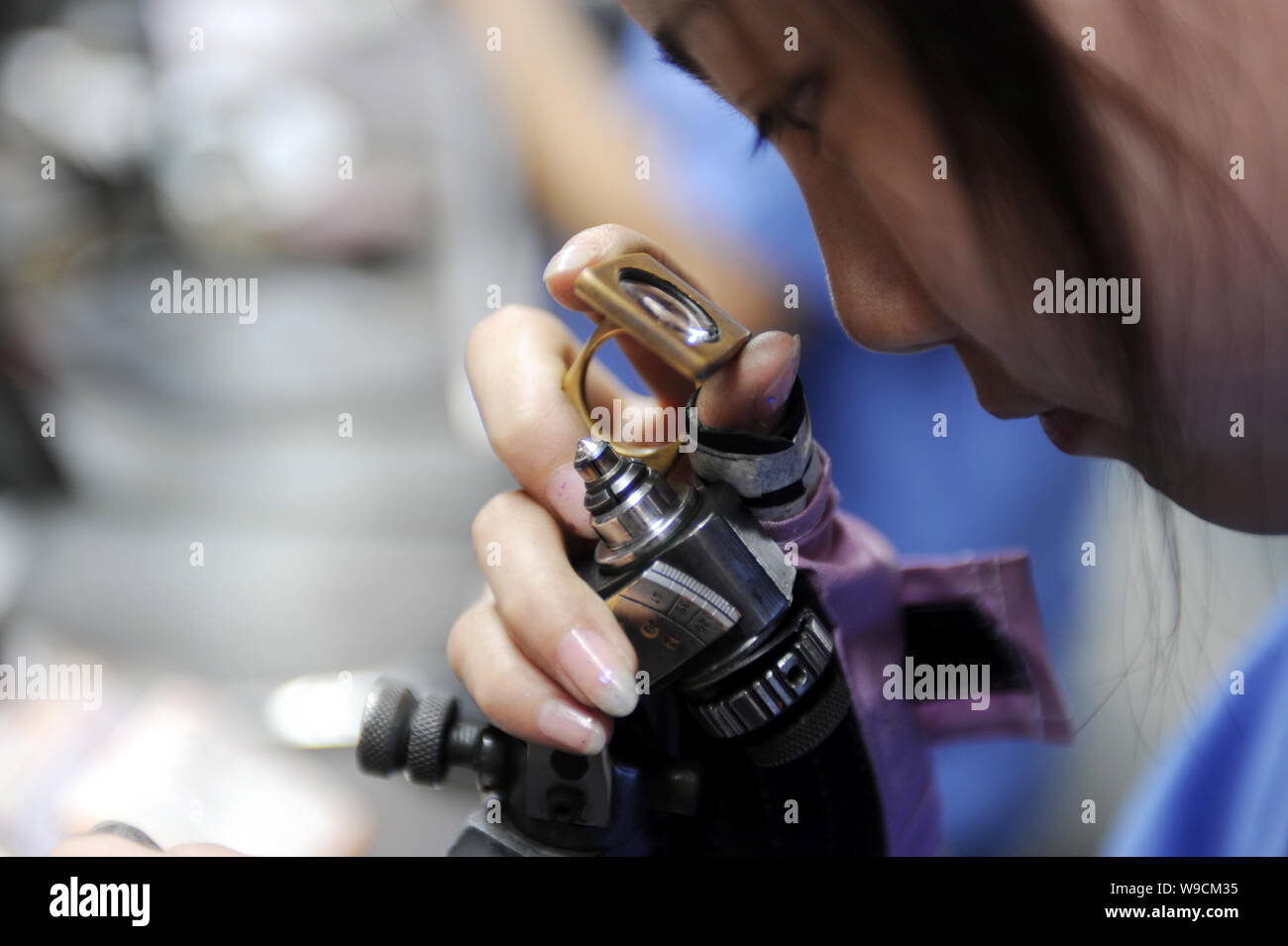 --FILE--A Chinese factory worker processes a diamond at a diamond ...