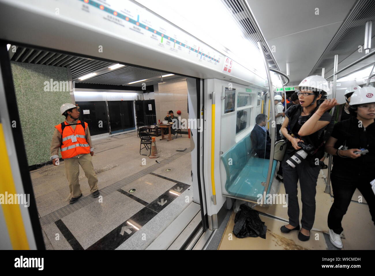 Chinese visitors are seen in a metro train of the Beijing Metro Line 4 ...