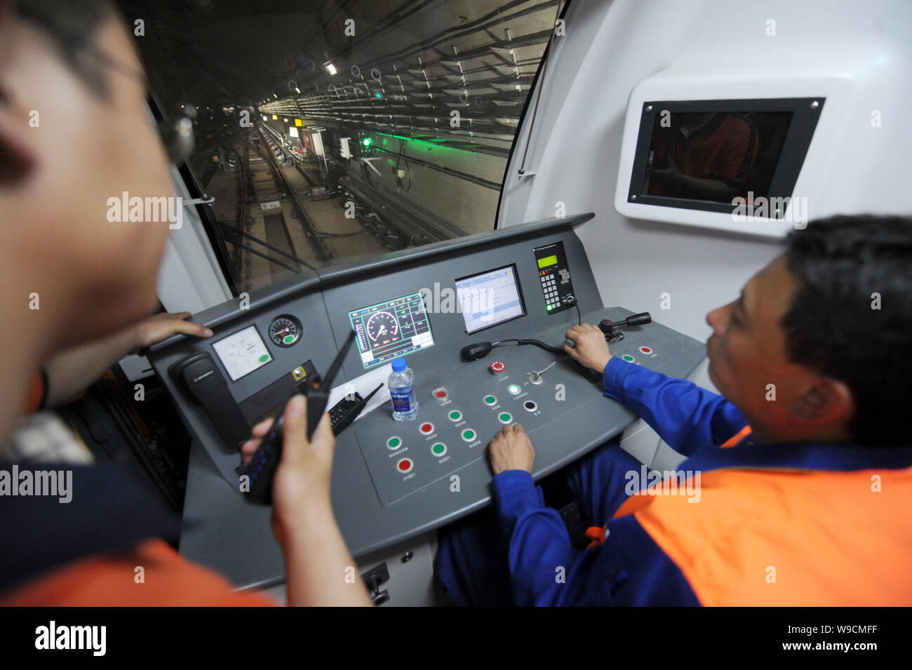 A Chinese man drives a metro train of the Beijing Metro Line 4 during a ...