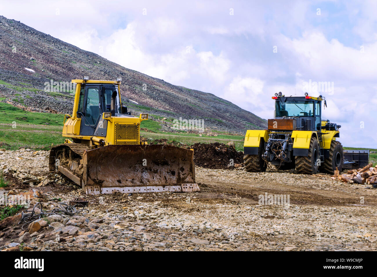 heavy machinery two bulldozers on the construction of roads in the ...