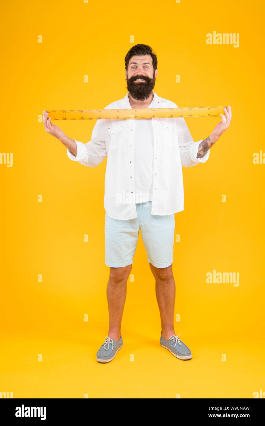 One meter. Man bearded hipster holding ruler. Measure length. Size tall ...