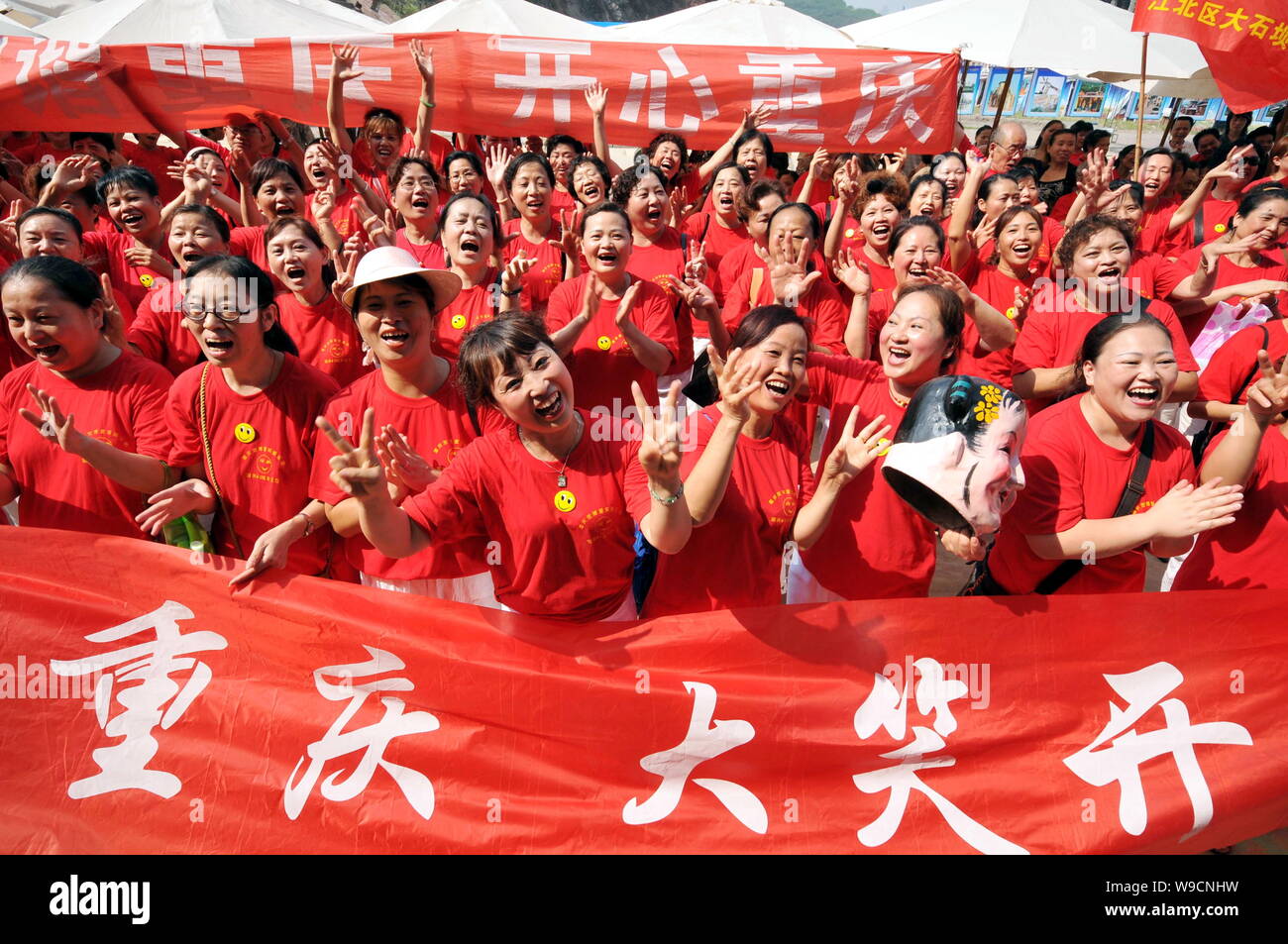 Local Chinese citizens laugh during a laughing campaign to celebrate ...