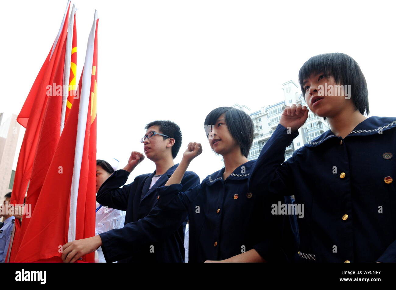 Chinese middle school students swear in during a ceremony to mark the ...