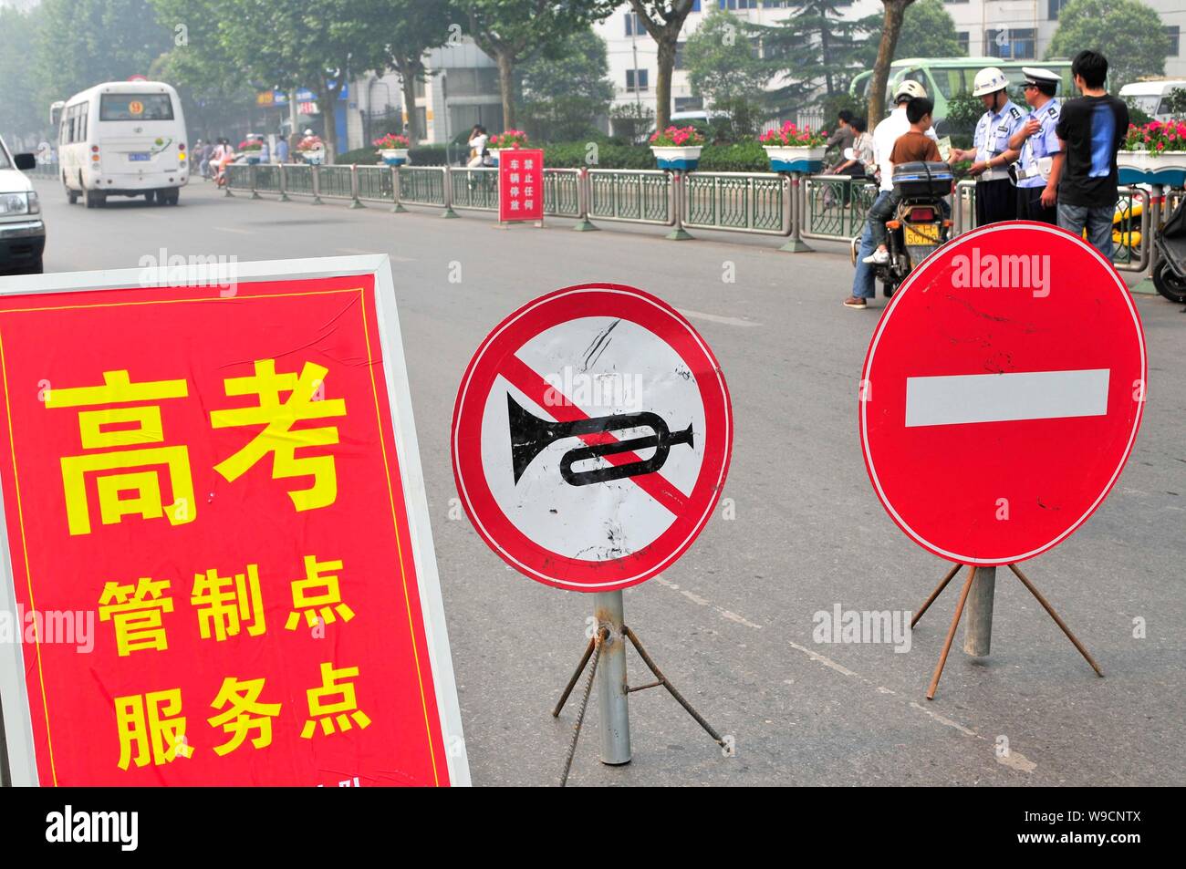 A No Honking warning and a No Entry sign are seen near an exam site of ...