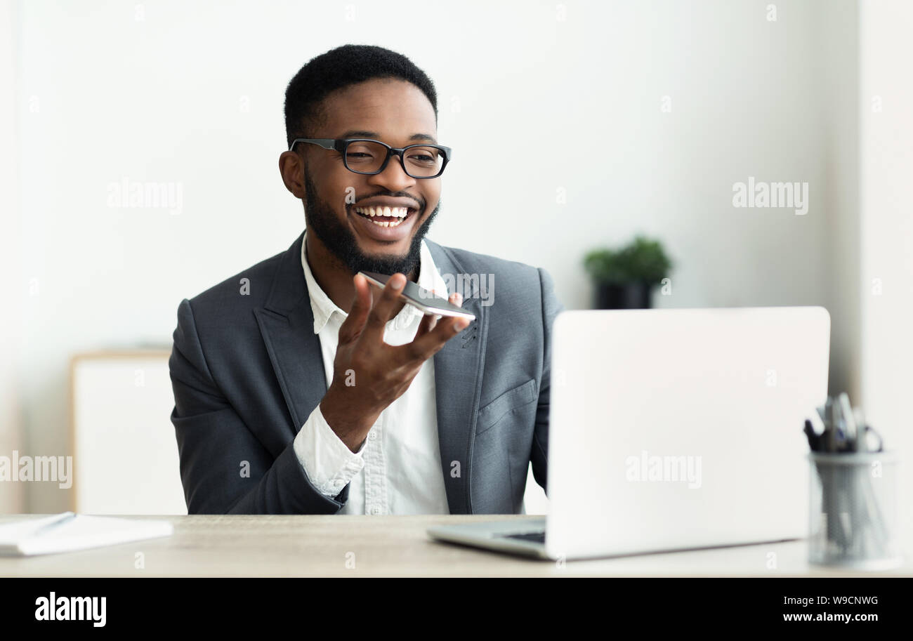 African American businessman using voice assistant on smartphone Stock ...
