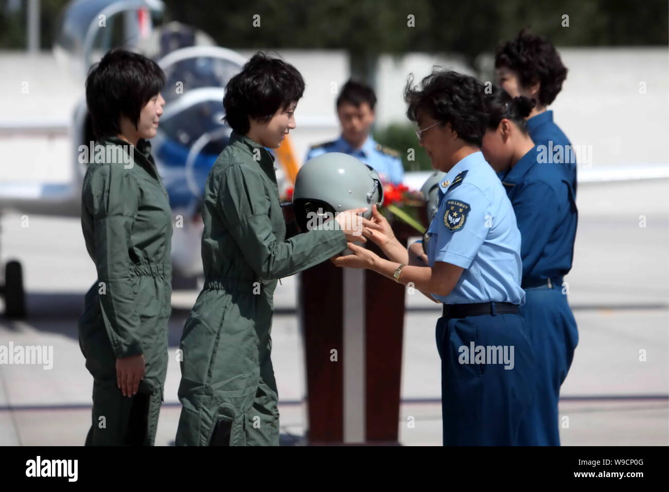 A veteran female pilot, front right, delivers the pilot helmet to a ...