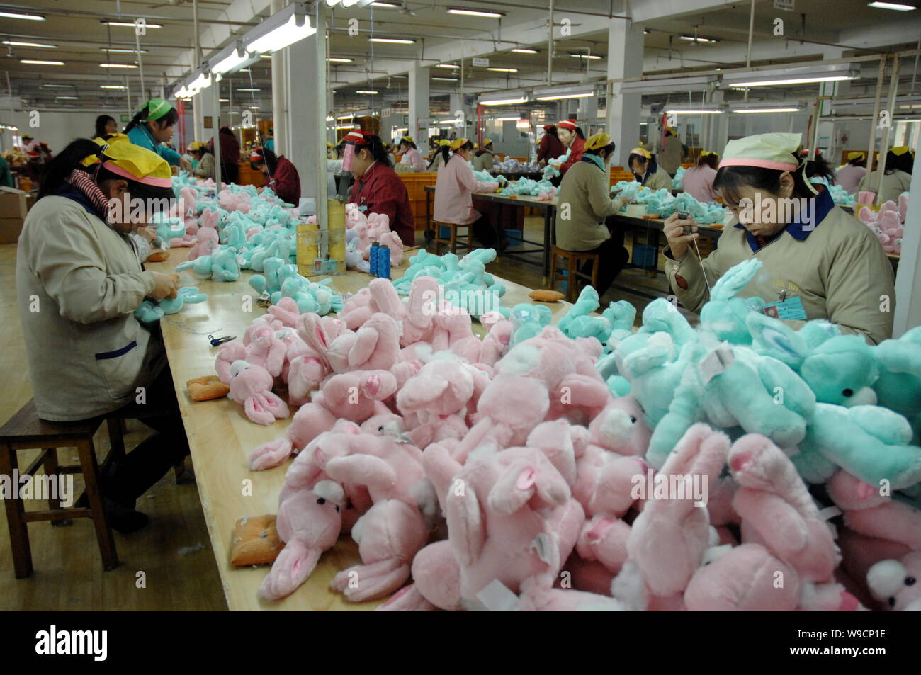 --FILE--Female Chinese factory workers make toy rabbits at the factory ...