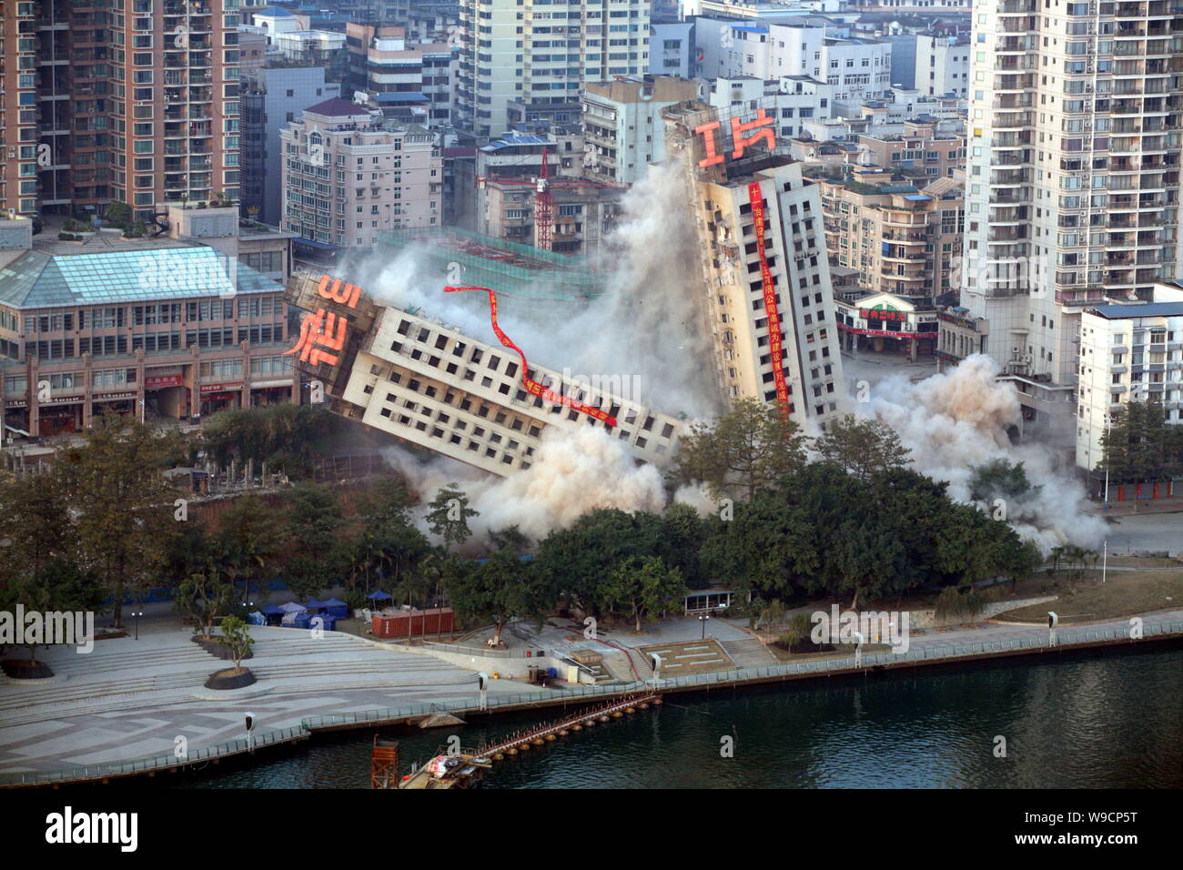 Two halves of a 22-story building are exploded during a demolition ...