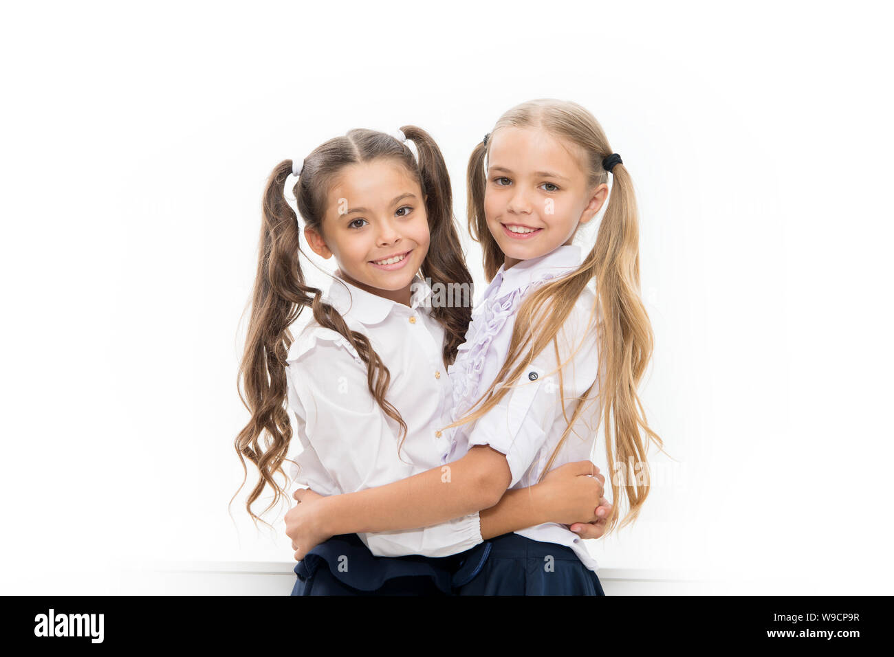 Happy childhood. Hug and love concept. Sincere kids. Kids schoolgirls ...