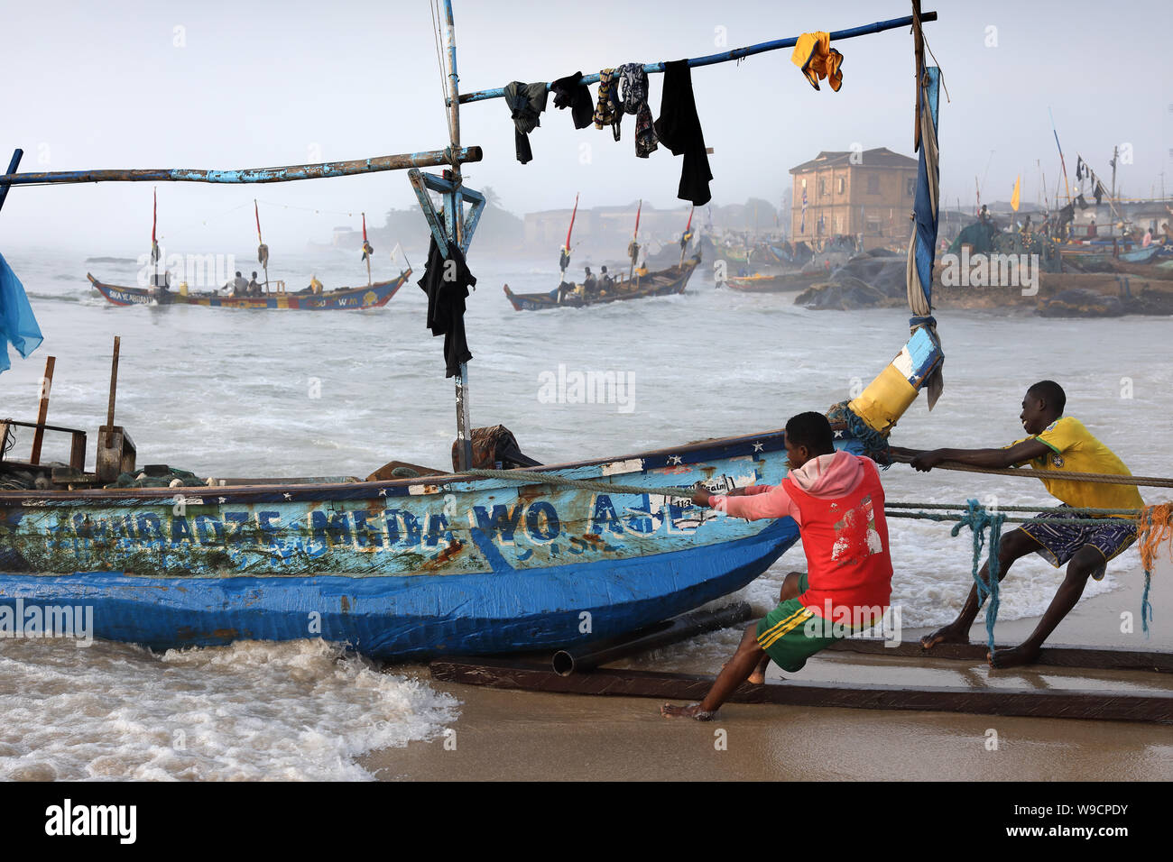 Fishermen pull a boat in Winneba, Ghana. Illegal fishing by foreign ...