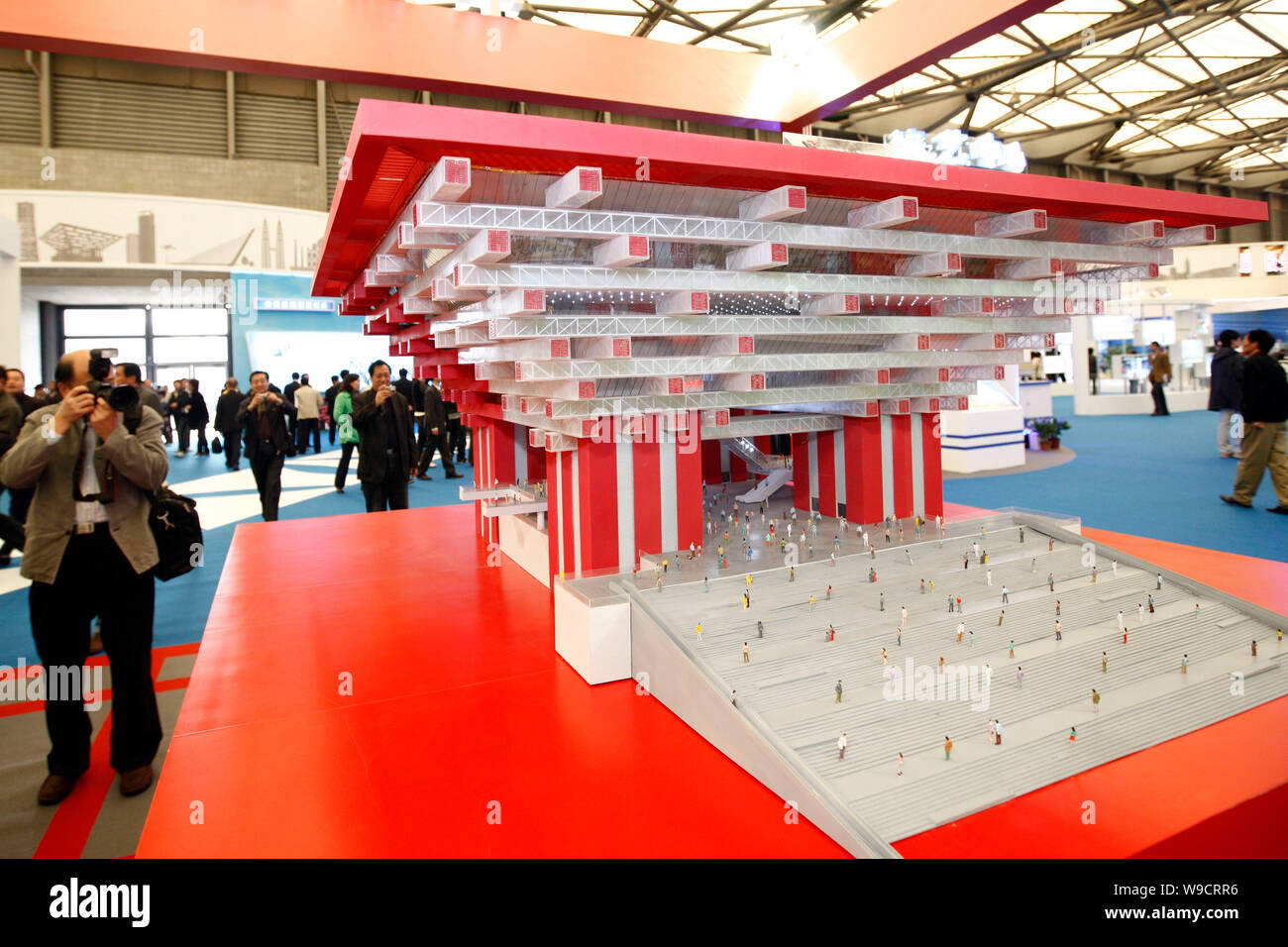Chinese visitors take photos of a model of the China Pavilion for the ...