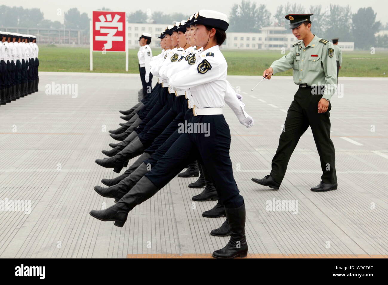 A Chinese PLA officer directs female soldiers during a military parade ...