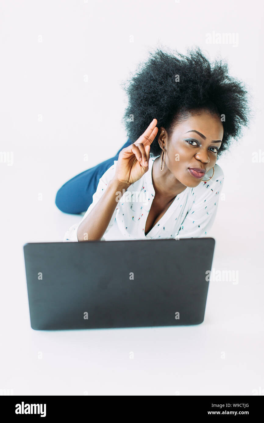 Young african american business woman using the laptop, while lying on ...