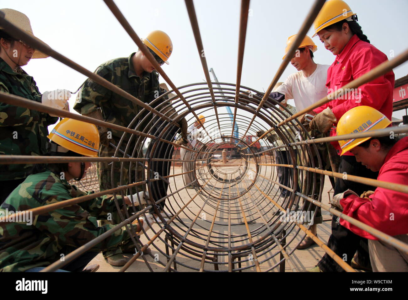 Chinese workers construct a steel structure for the construction of the ...