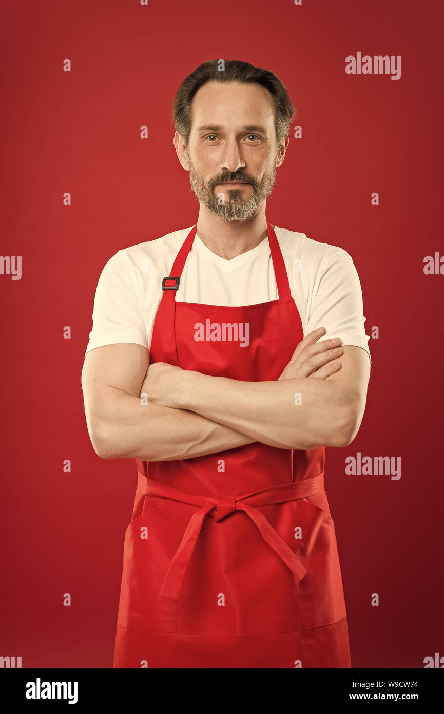 Confident in his culinary craft. Cook with beard and mustache wearing ...