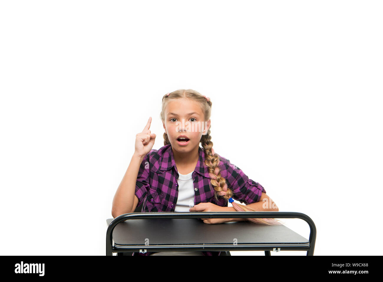 Homework idea. Little girl keeping finger raised isolated on white ...