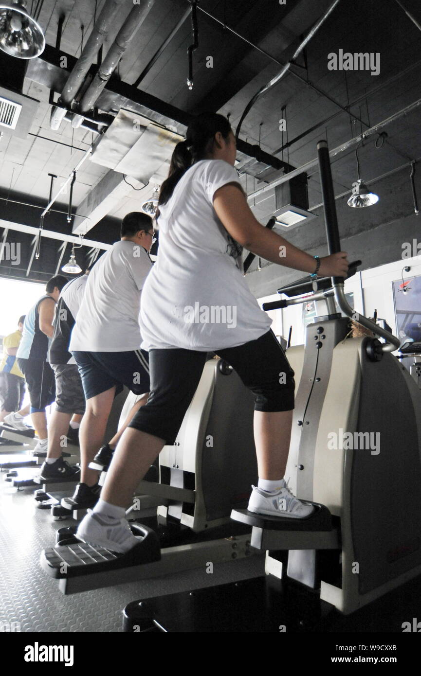 Chinese obese children exercise on steppers during a weight reduction ...