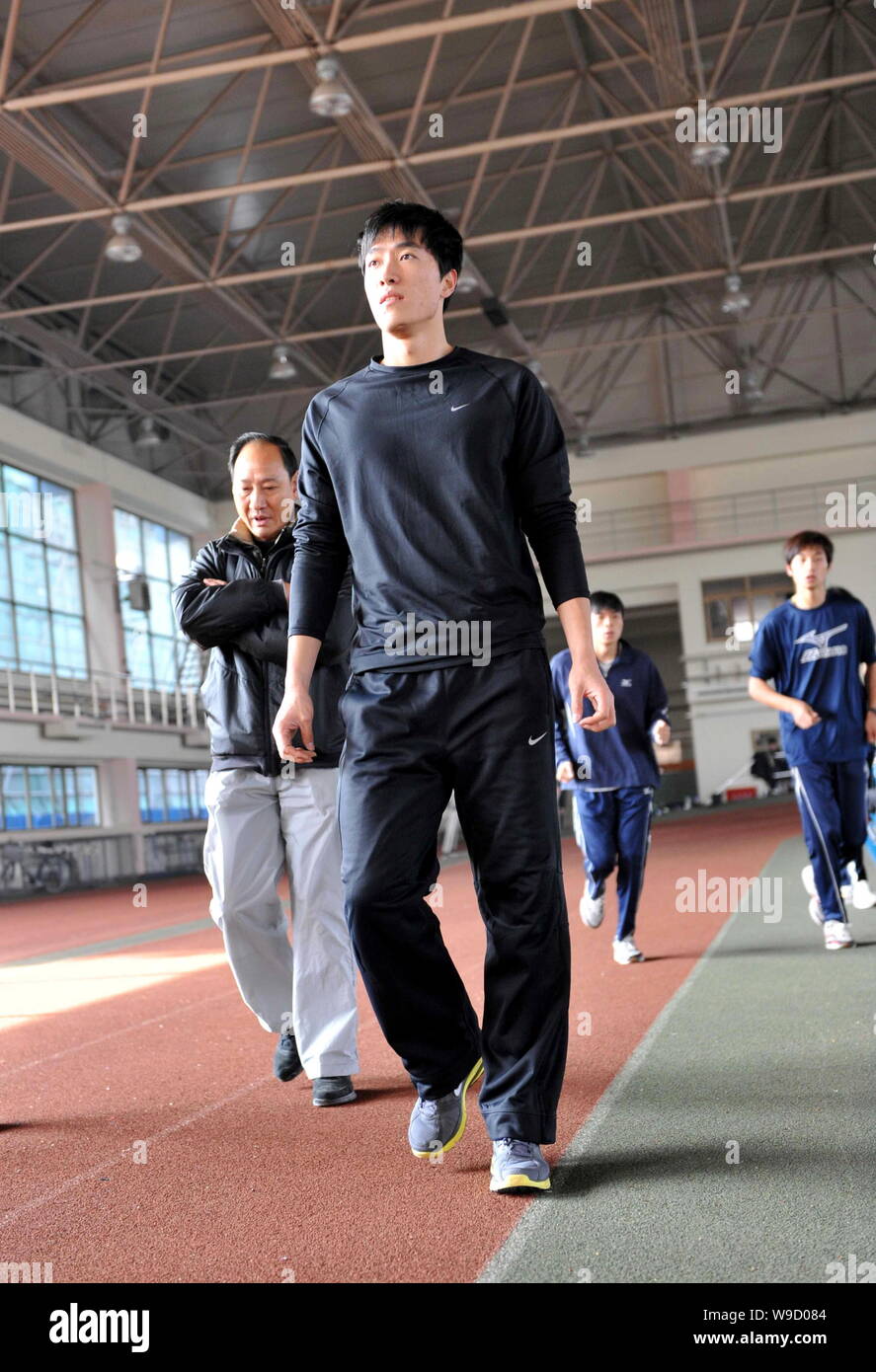 Chinese hurdler Liu Xiang, right, walks past his coach Sun Haiping ...