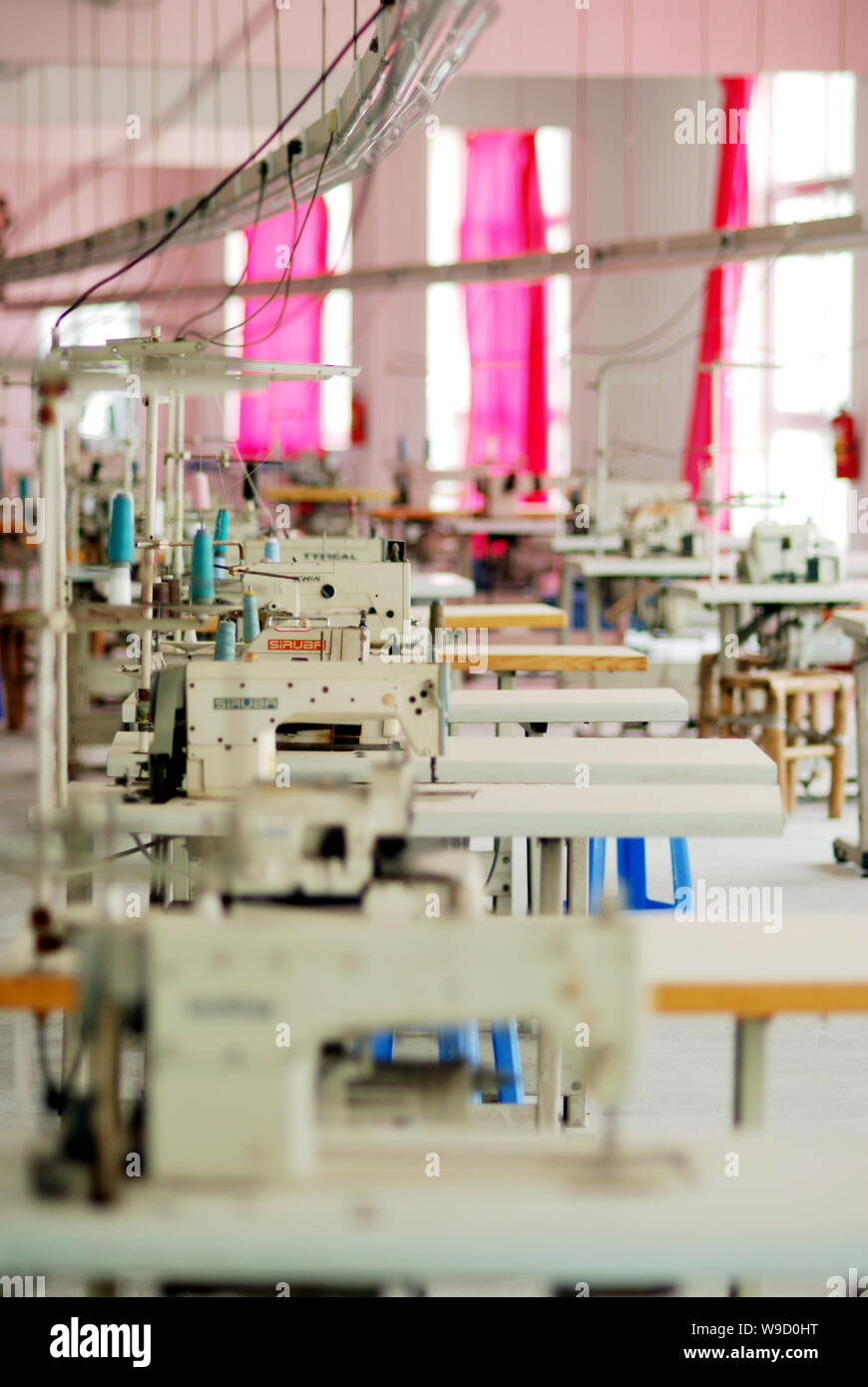 Vacant sewing machines are seen at an empty garment factory in Zhuzhou ...