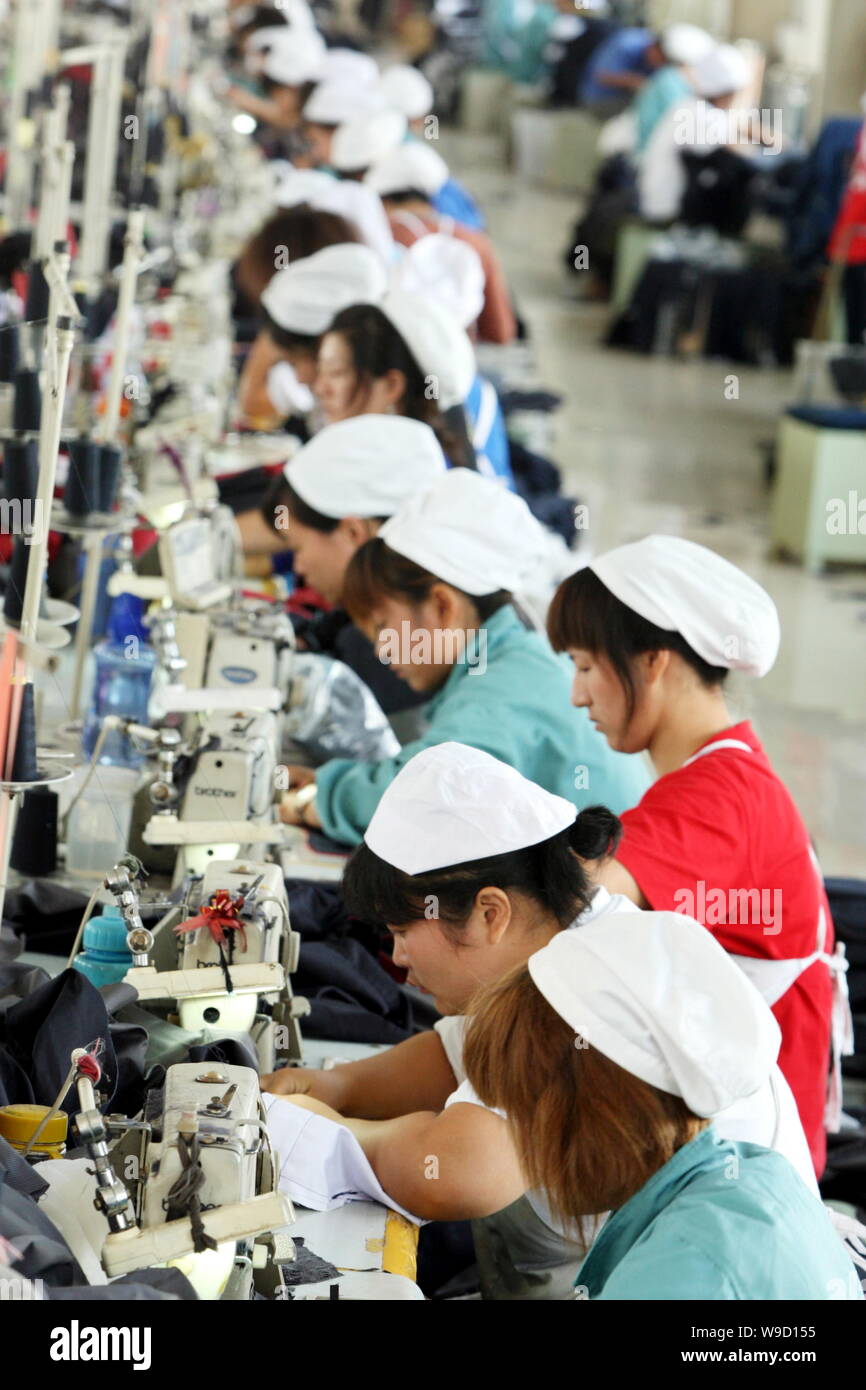 --FILE--Female Chinese factory workers manufacture clothes to be ...
