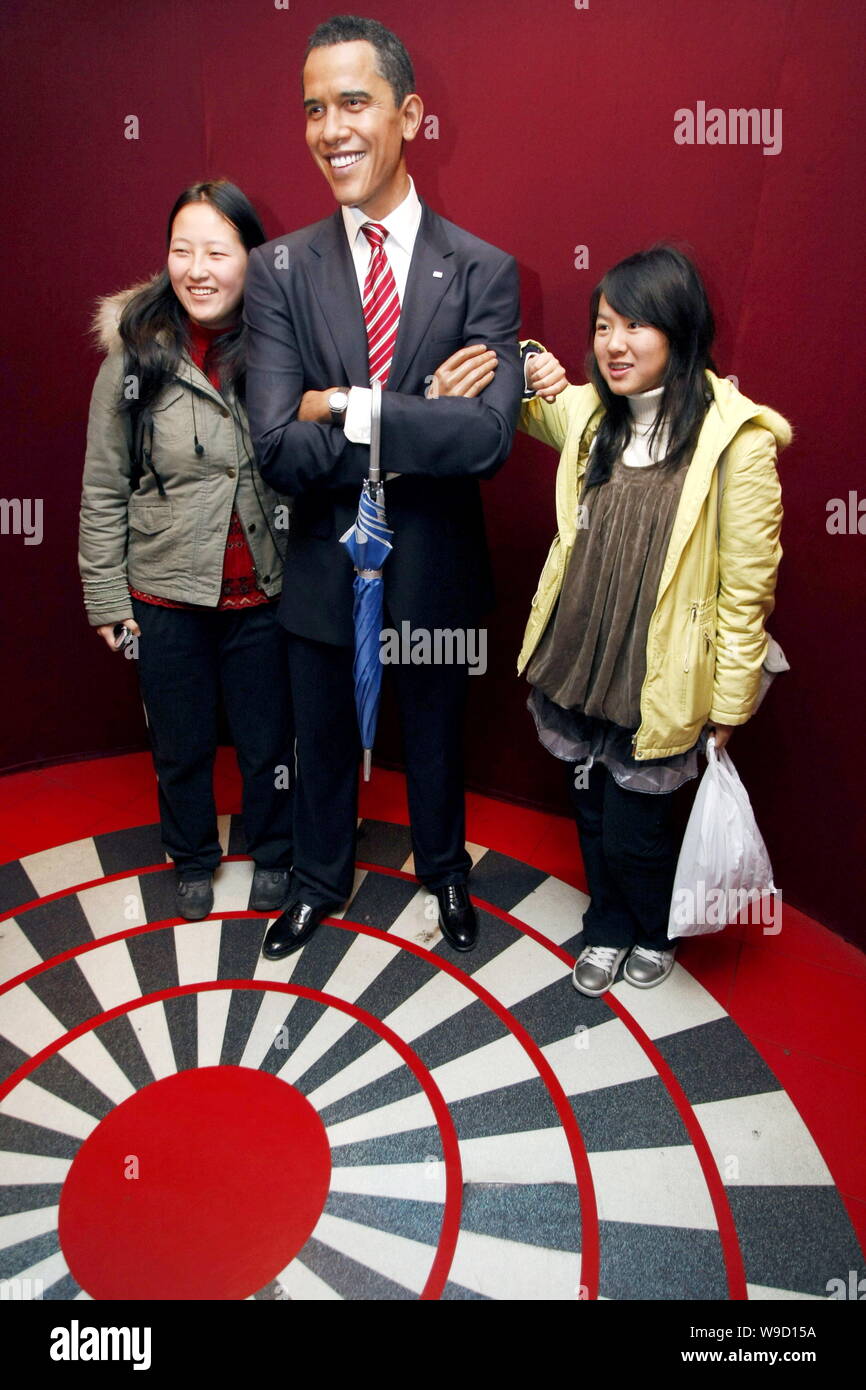 Chinese visitors pose next to a wax figure of U.S. President Barack ...
