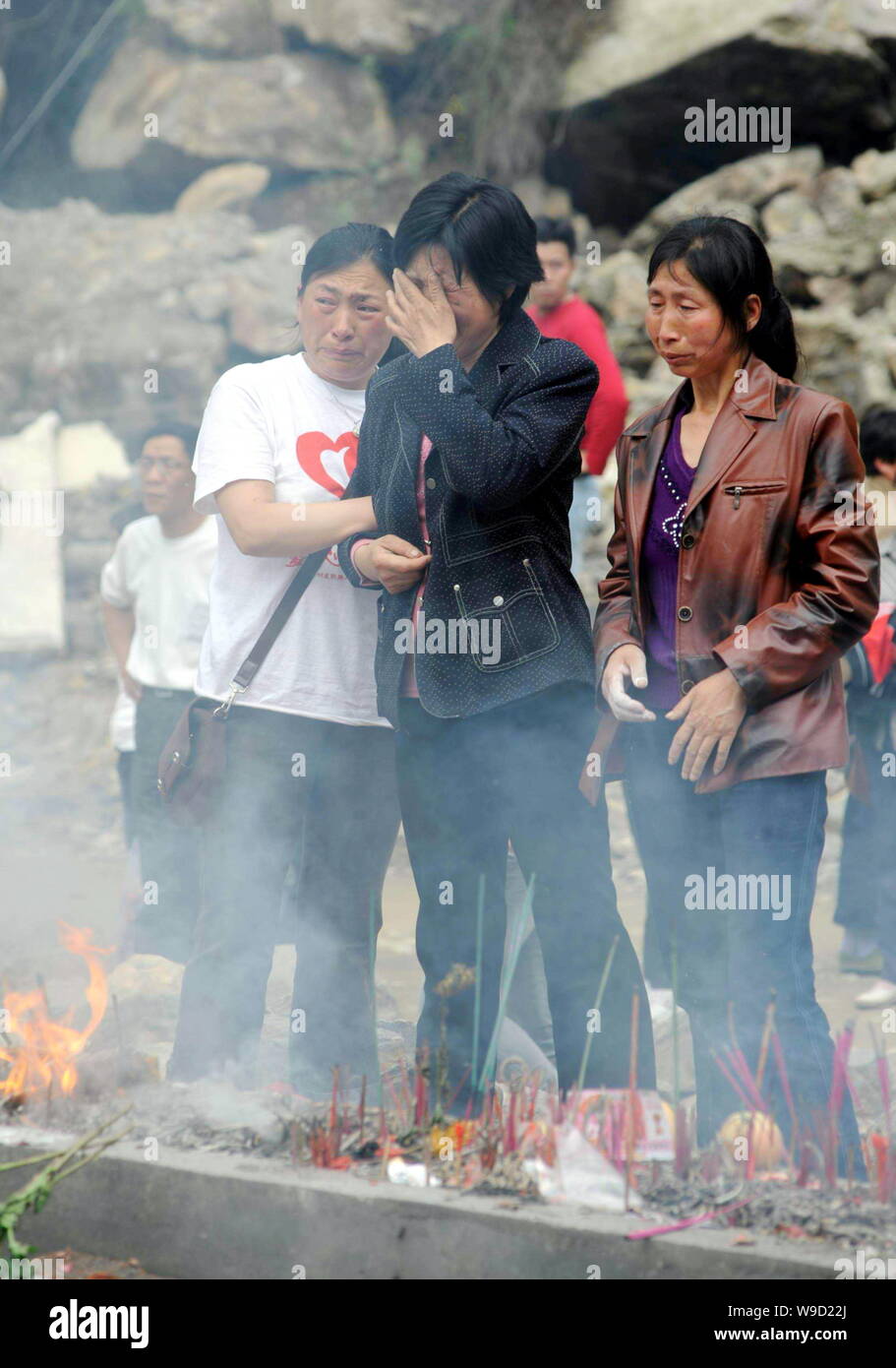 Chinese visitors cry over their family members who died in the May 12 ...