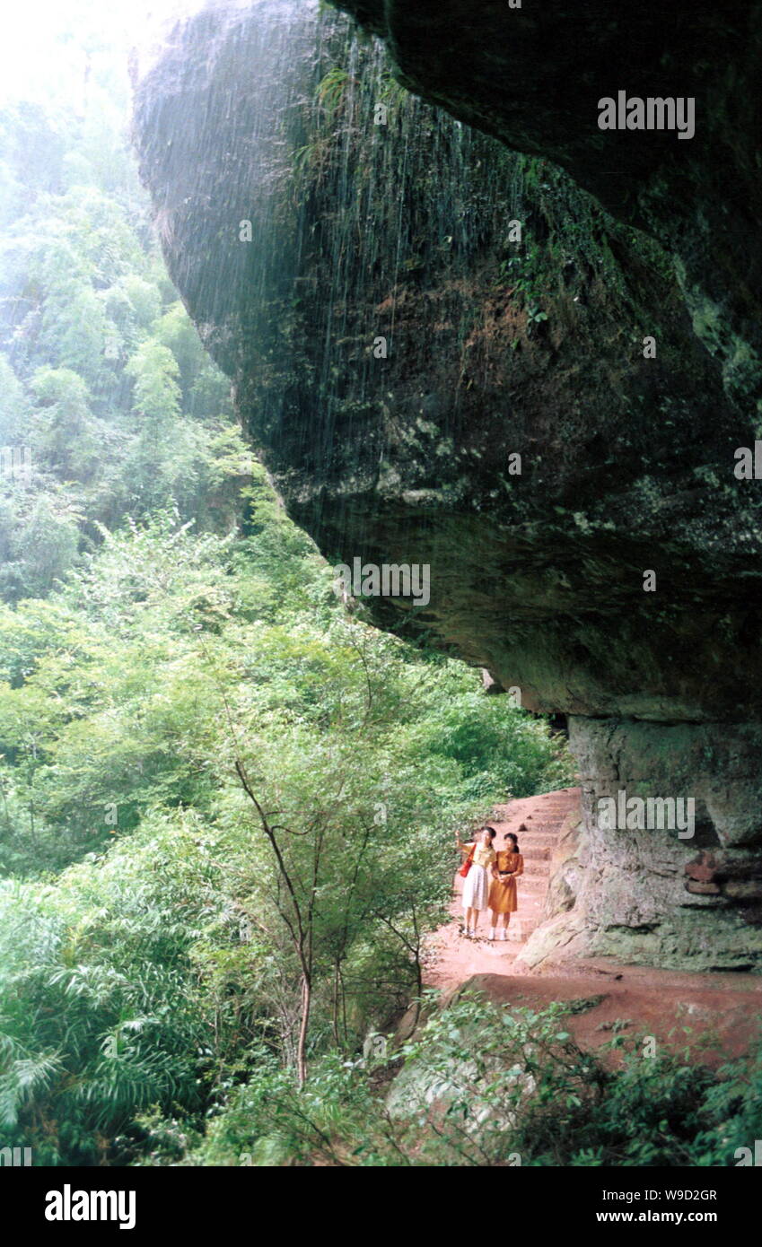 Tourists look at a waterfall in the Yandang Mountain senic spot in ...